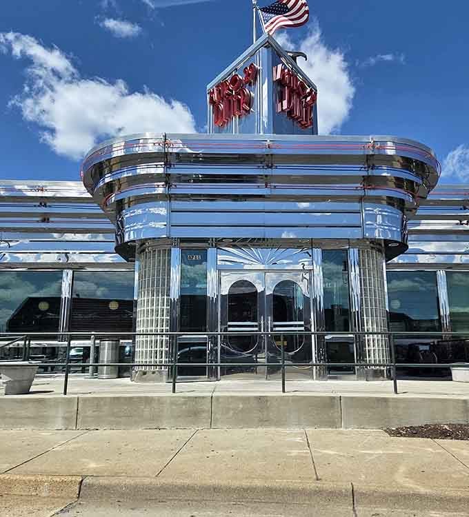 Under a wide blue sky, Metro 29 Diner's polished chrome entrance shines like a beacon for anyone craving classic American comfort.