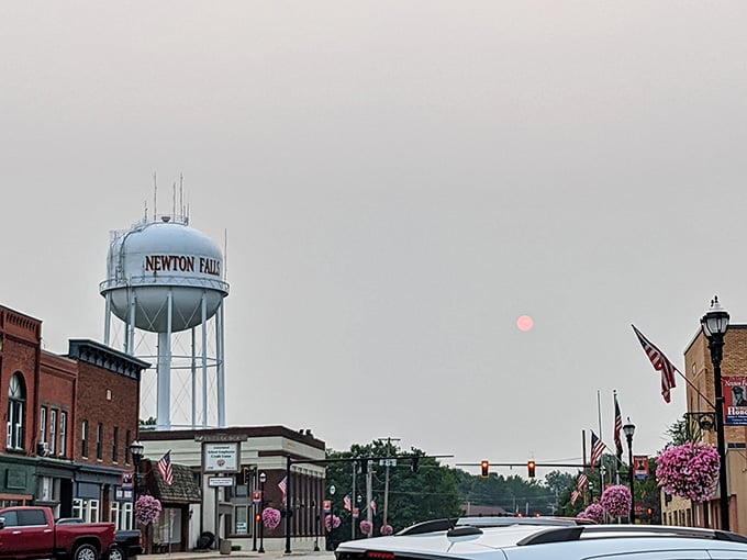 A hazy red sun hangs over Newton Falls downtown like nature decided to add its own dramatic filter.