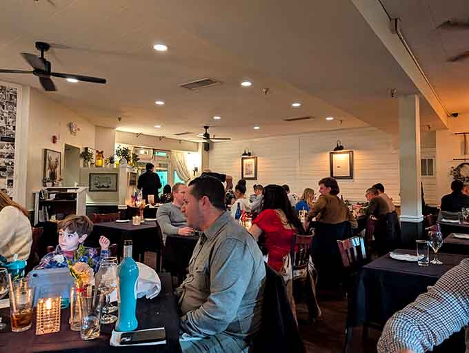 Candlelight, a buzzing crowd, and warm white walls covered in photos — Prime 13's dining room hums with genuine Shore-town energy.