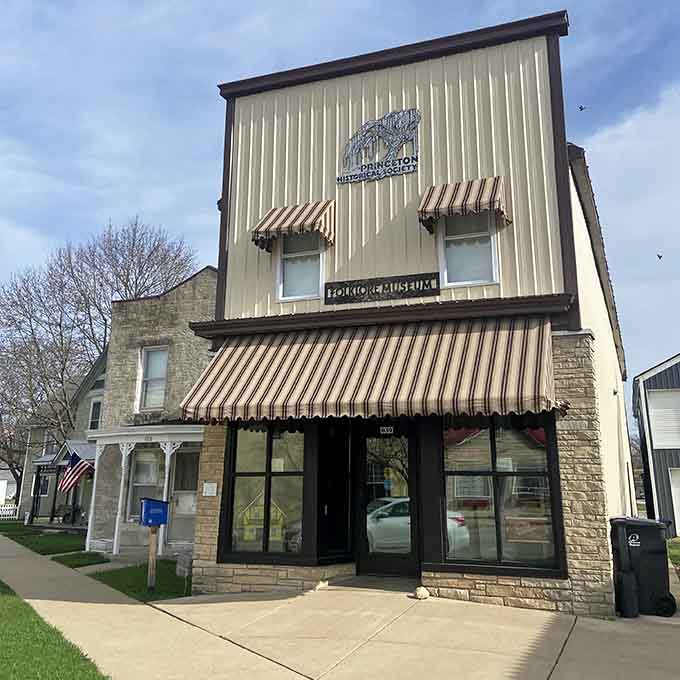 The striped awnings give this building character that modern construction just can't replicate, no matter how hard it tries.