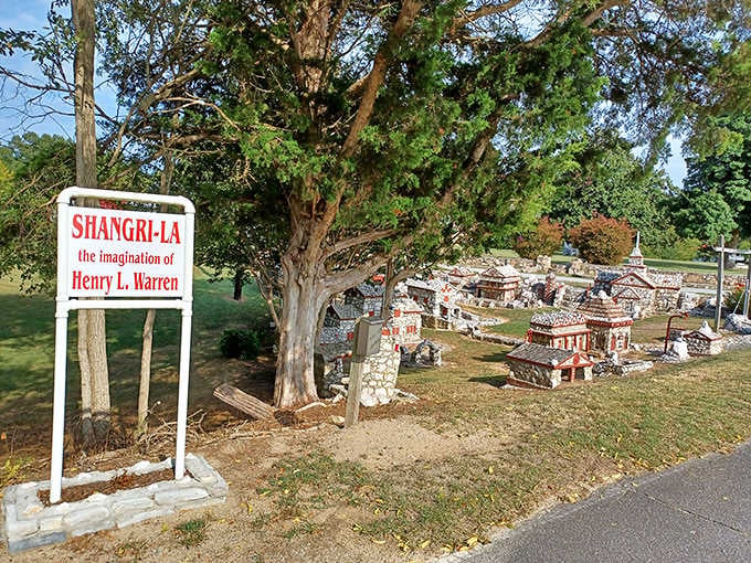 The roadside sign reads "Shangri-La, the imagination of Henry L. Warren," and honestly, that tells you everything you need to know.