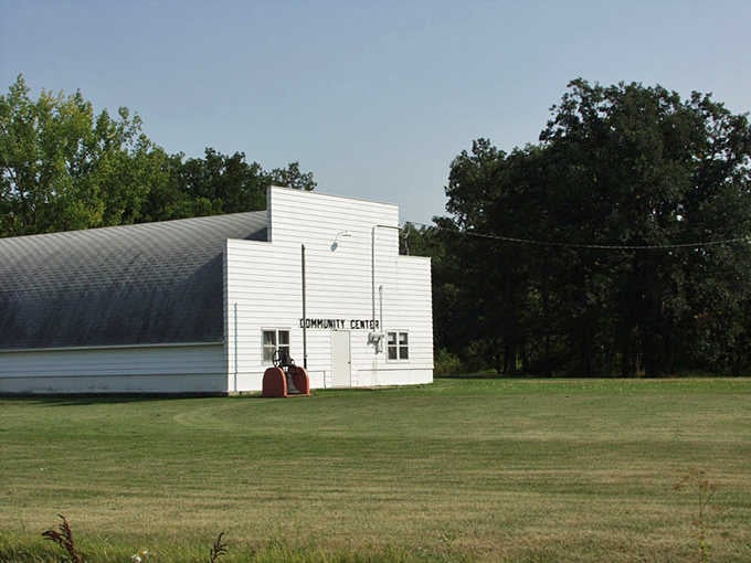 That simple white community center sitting on a green lawn is the quiet heartbeat of St. Vincent's neighborhood life.