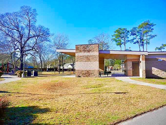 A stone pavilion stands quietly beneath tall Carolina pines, giving Trent Woods' neighborhood park a peaceful, almost meditative atmosphere.