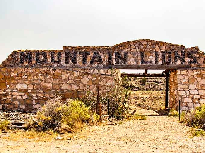 "Mountain Lions" carved in stone above an empty doorway at Two Guns, a sign that once meant business and now means something far eerier.
