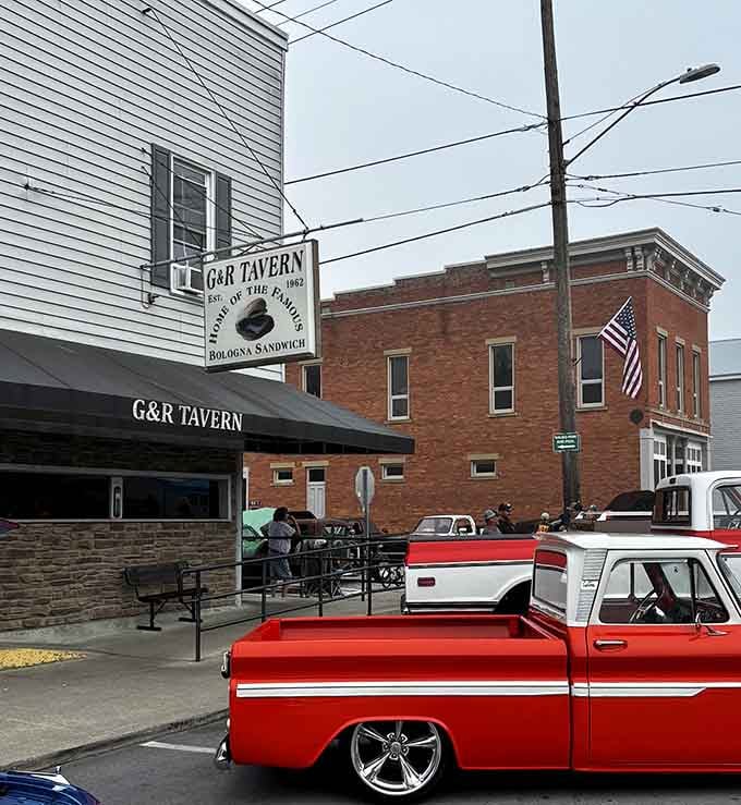 That classic tavern sign and restored pickup truck tell you everything: authentic food, genuine people, no pretense required.