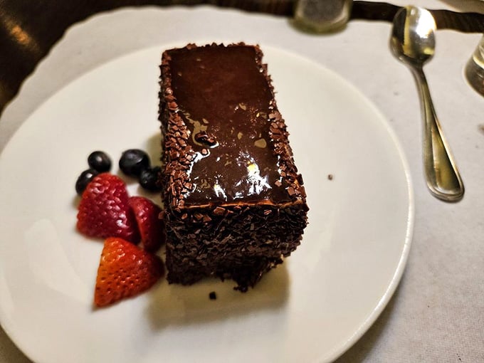 Dense chocolate cake with fresh berries is the kind of dessert that makes you remember why you saved room.
