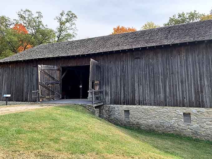 Weathered timber walls and a stone foundation tell you this barn has quietly outlasted just about everything around it.