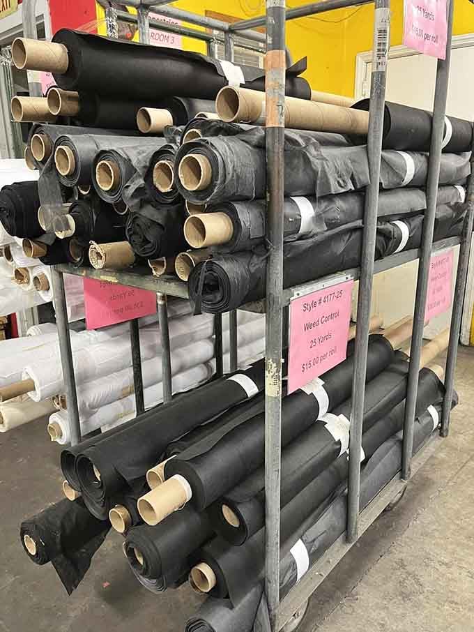 Rolls of black fabric stacked high and serious, the unsung workhorse of every great sewing project ever made.