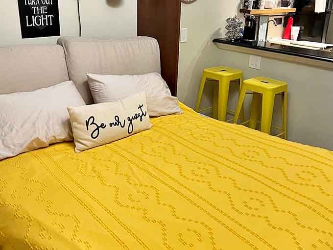 A bright yellow bedspread and a "Be Our Guest" pillow, because someone here really means it.