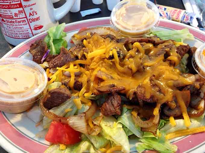 Steak, melted cheese, grilled onions, and fresh greens piled high. This salad means serious, unapologetic business.