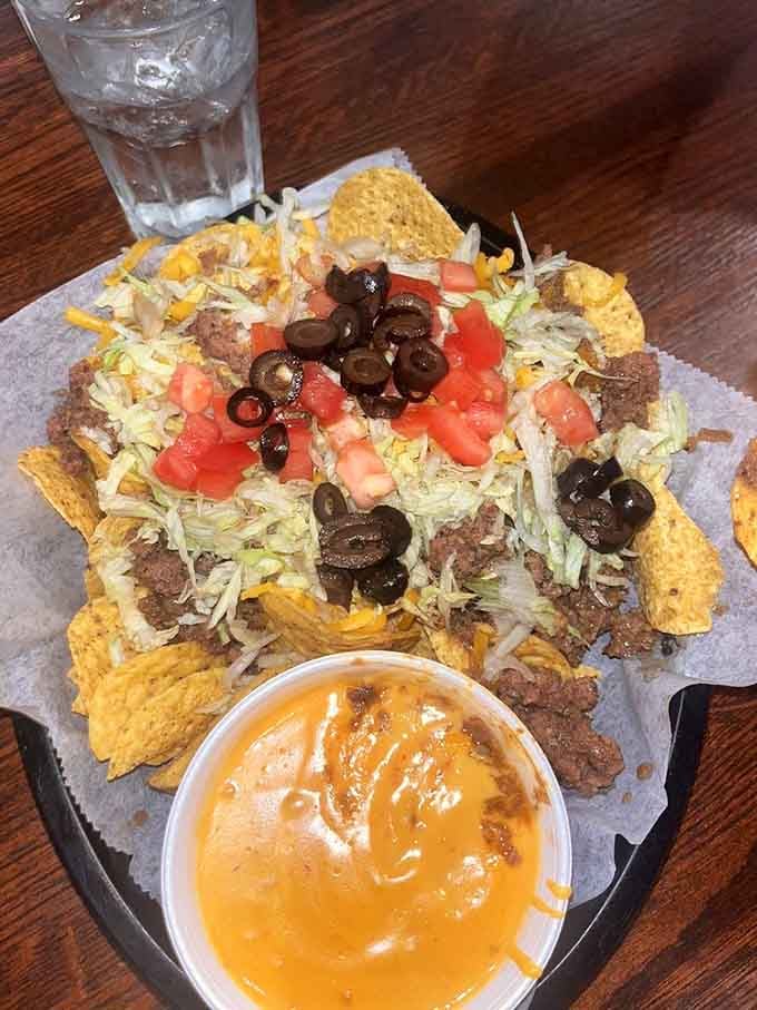 Nachos loaded with all the fixings and a side of cheese sauce, because apparently regular cheese wasn't quite enough cheese.