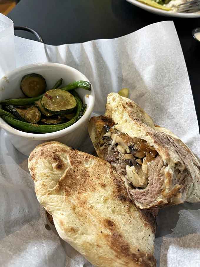 Stone hearth-baked bread wrapped around short rib and mushrooms, served with a side of vegetables that actually look worth eating.