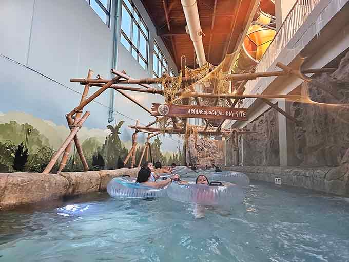 Floating past an "Archaeological Dig Site" sign on a lazy river is peak indoor adventure, honestly.