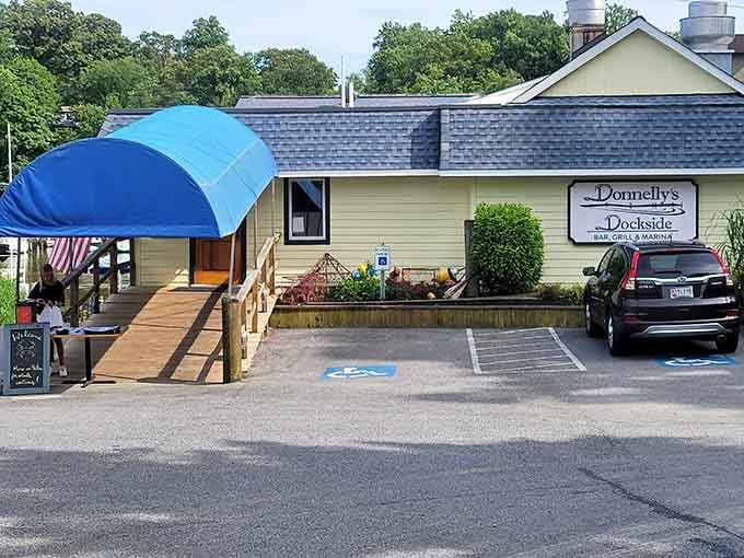 That cheerful blue canopy at Donnelly's Dockside says everything you need to know: pull up a chair, the water's right around back.