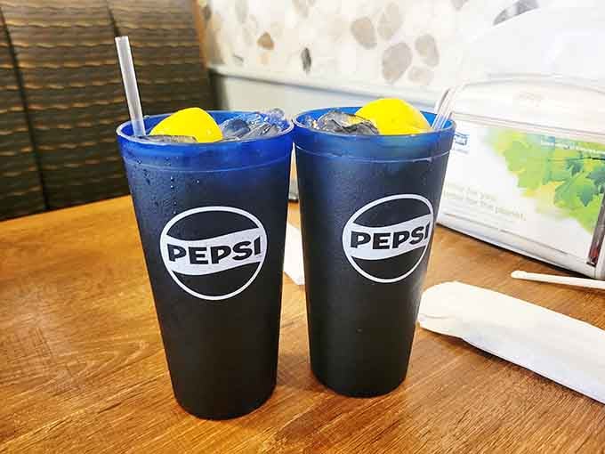 Two cold drinks with lemon wedges, ready and waiting. The meal hasn't even started, and already things are looking up.