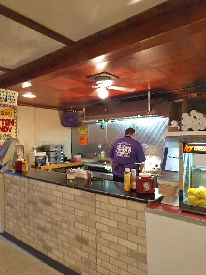 Behind that counter, someone's making sure your hot dog is ready before the opening credits roll. True dedication.