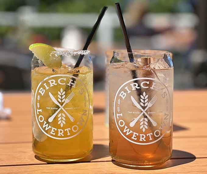 Birch's signature cocktails in branded glassware promise refreshment with a view on the sunny patio.