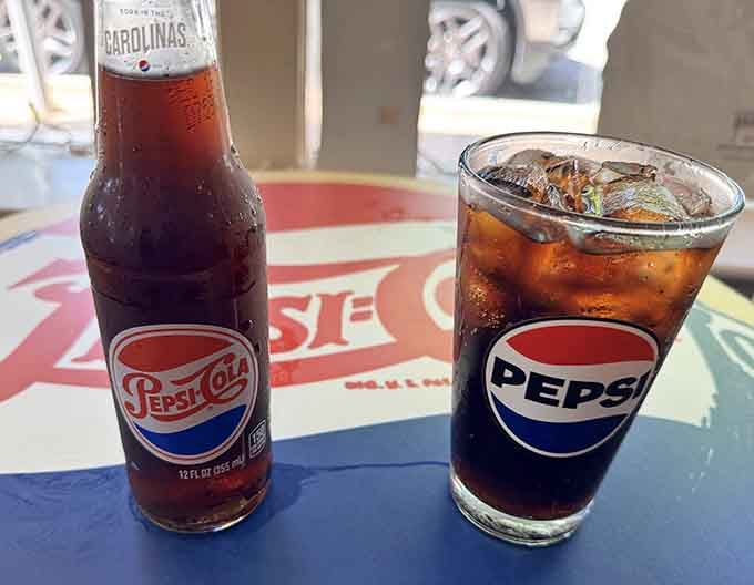 A classic glass bottle and a branded Pepsi glass, cold, fizzy, and tasting better at the source.
