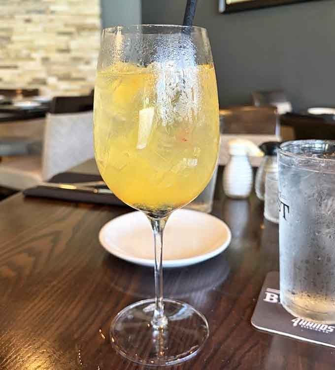 A golden, icy drink that looks like sunshine in a wine glass. The perfect companion for patio dining.