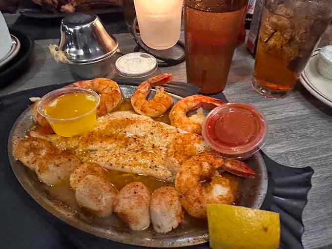 Fish, shrimp, and scallops sharing one platter with drawn butter nearby, this is what a good evening looks like.