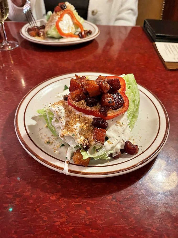 A wedge salad dressed up with caramelized bacon and tomato. Simple ingredients, serious execution, zero complaints.