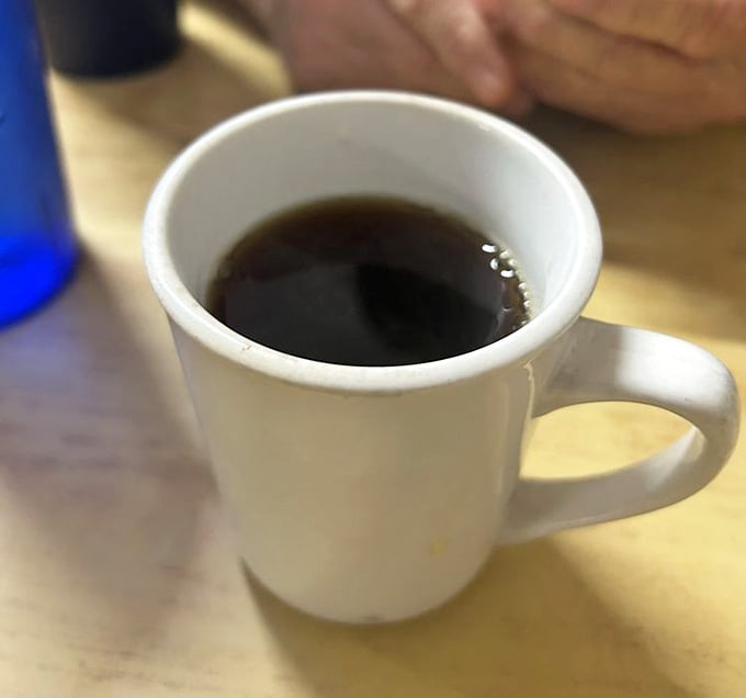 A simple white mug filled with hot black coffee &mdash; sometimes the most honest things in life are also the most satisfying.