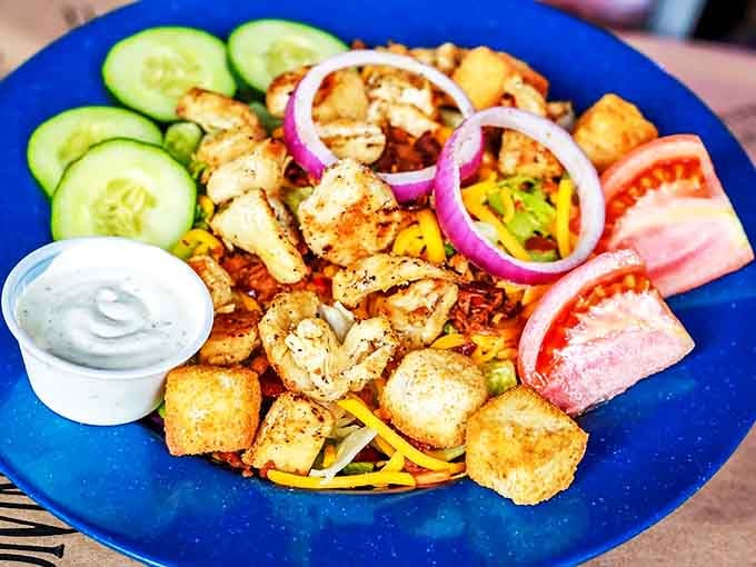 A loaded salad with grilled chicken, fresh vegetables, and croutons. Even the salad here looks like it means business.