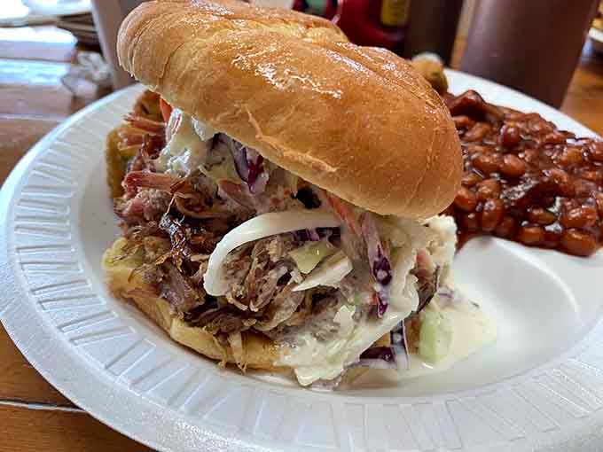 Pulled pork piled high with coleslaw on a golden bun, with pit beans alongside, this sandwich means serious business.