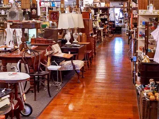 Polished hardwood floors lead you deeper into a corridor packed with furniture and quiet discoveries.