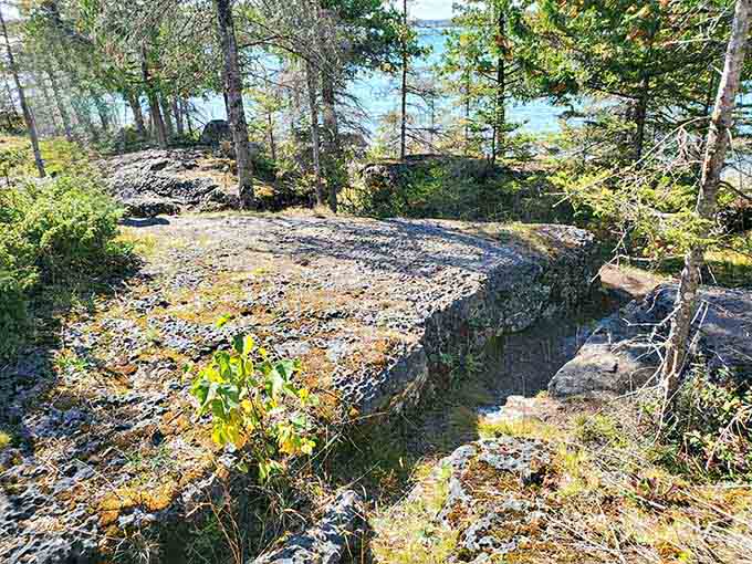 Grey stones look out over the brilliant blue waters, offering a scenic rest stop along the coast.