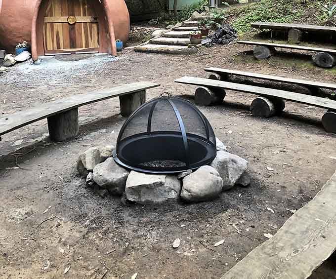 A stone fire pit surrounded by log benches and a terracotta dome. This is where good stories get told.