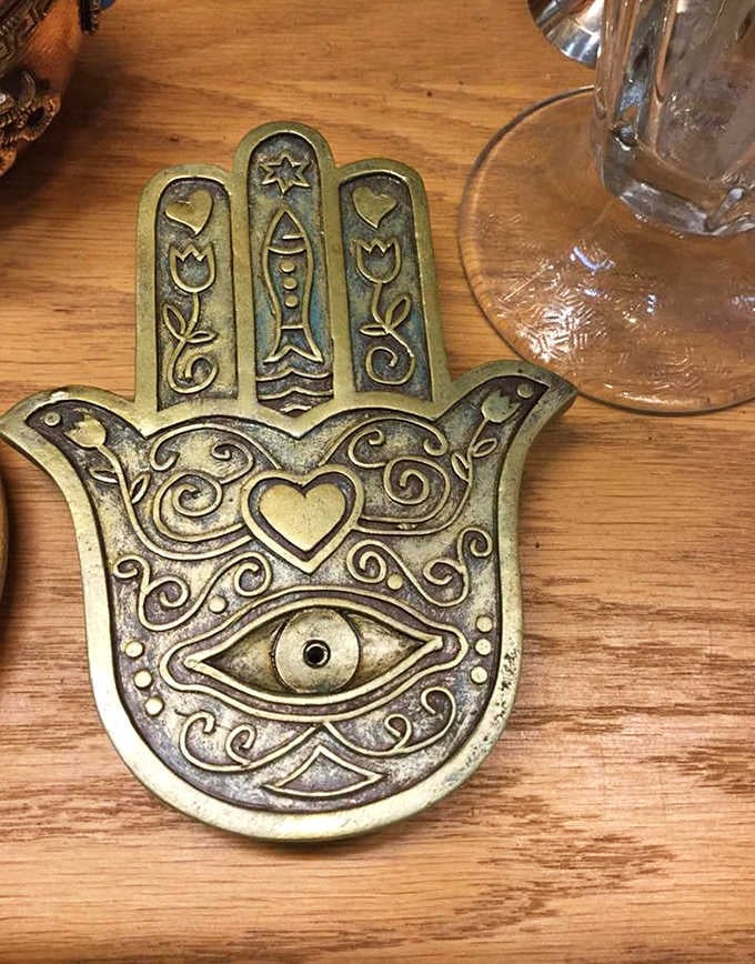 A brass Hamsa sitting quietly on the counter, watching over everything with remarkable patience and style.