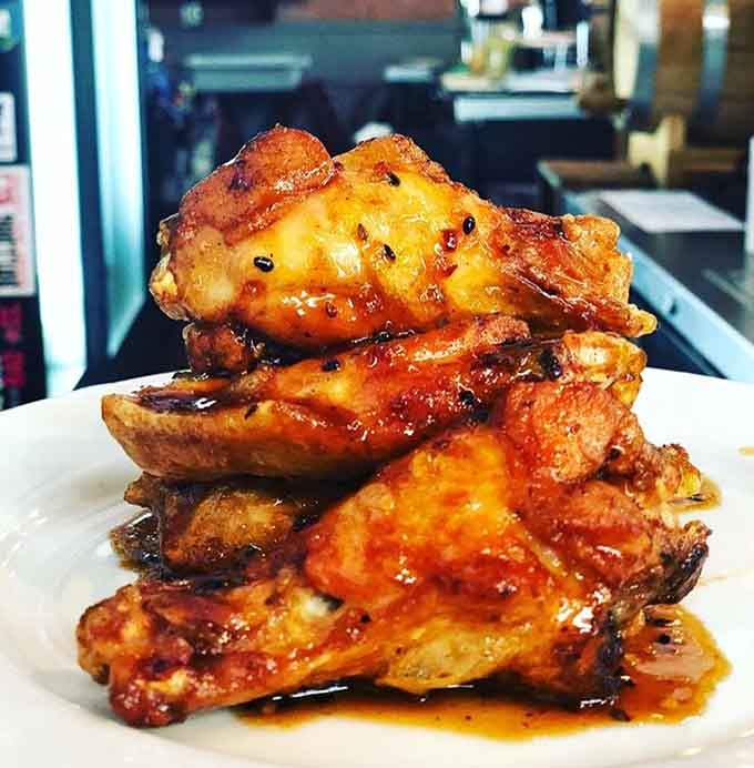 These glazed wings stacked high are what happens when someone takes chicken seriously and wins gloriously.