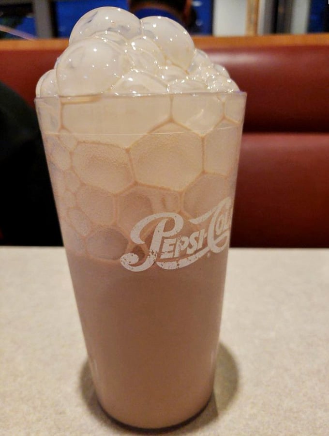 A towering chocolate shake crowned with whipped cream reminds you that calories don't count when you're this happy.