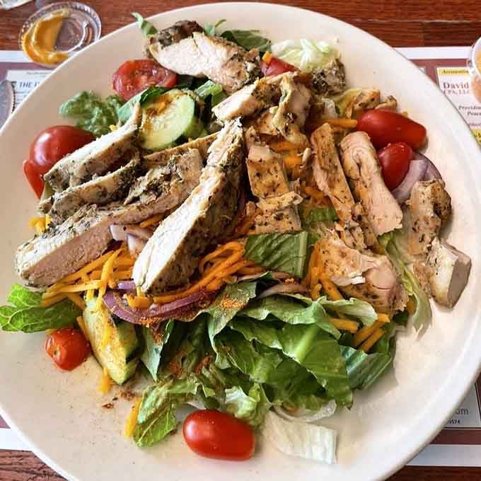 Grilled chicken over fresh greens proves the Clinton Station Diner takes lighter fare just as seriously as the giants.