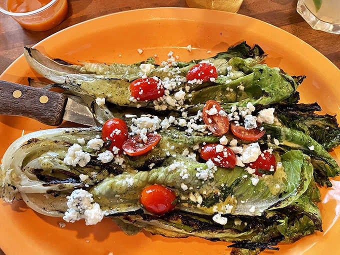 Grilled romaine, cherry tomatoes, and crumbled cheese — proof that salad can actually be the most exciting thing on the table.