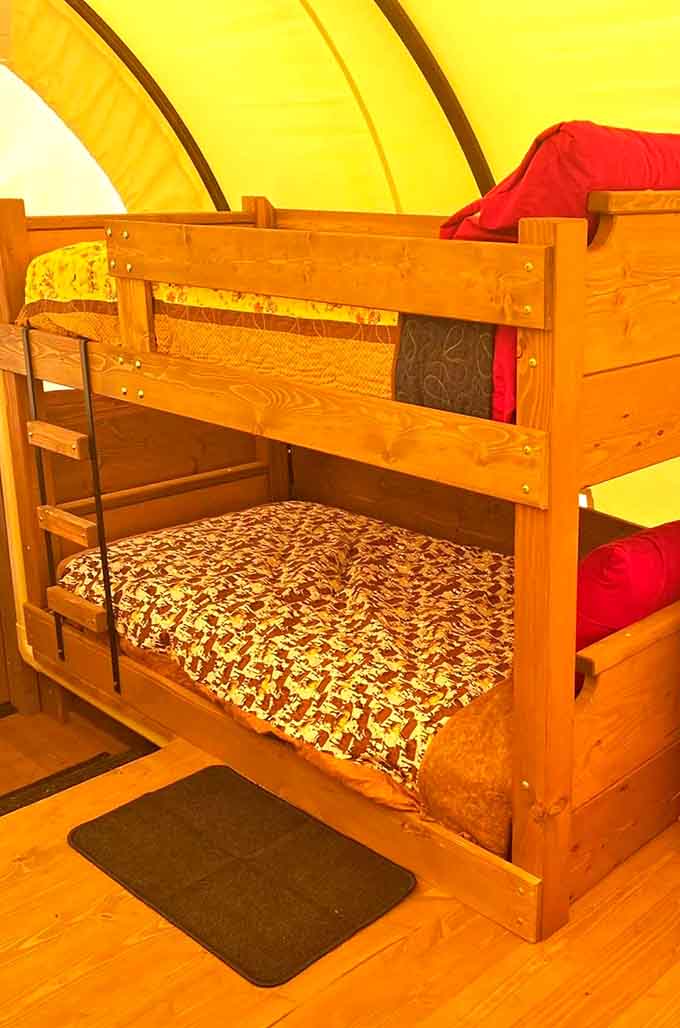 Bunk beds inside a covered wagon. Kids everywhere just added this to their must-do list immediately.
