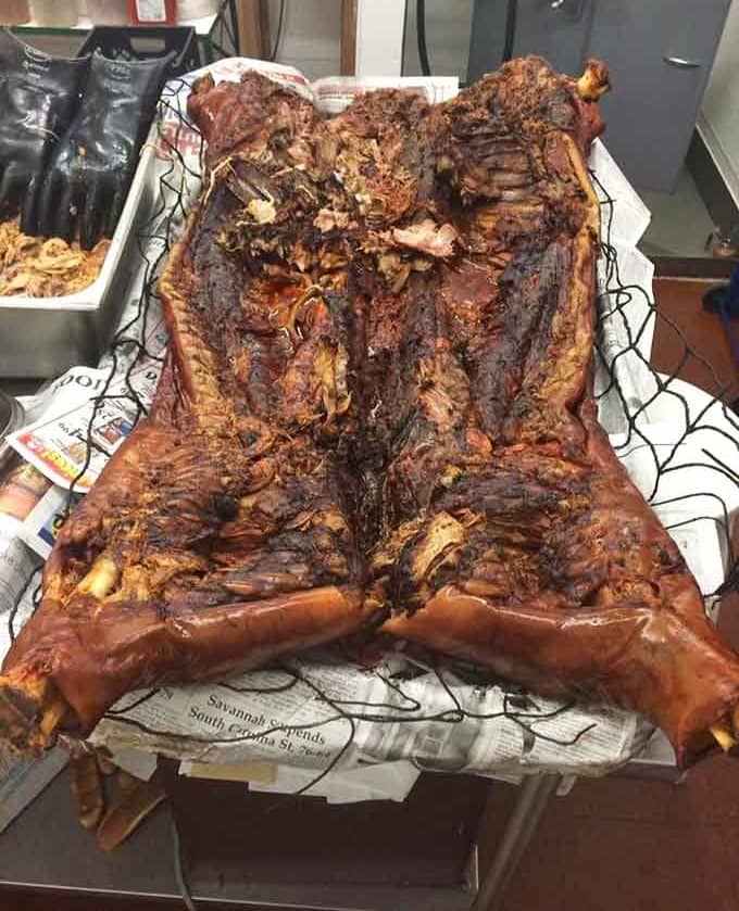 A whole hog, cooked low and slow, laid out like the grand finale of a South Carolina tradition.