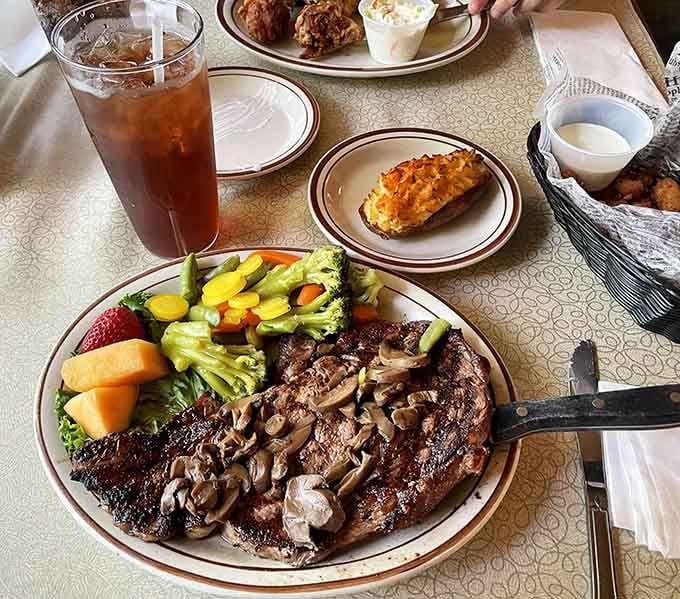 A ribeye buried under saut&eacute;ed mushrooms, with a twice-baked potato alongside. Tuesday suddenly feels like a celebration.