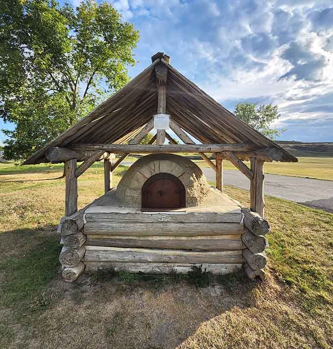 A beautifully reconstructed historic bread oven, sitting quietly on the grounds like a delicious secret from another century.