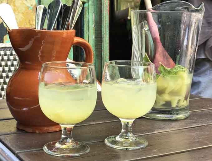 Mojitos served in proper glassware because some drinks deserve respect and fresh mint by the handful.