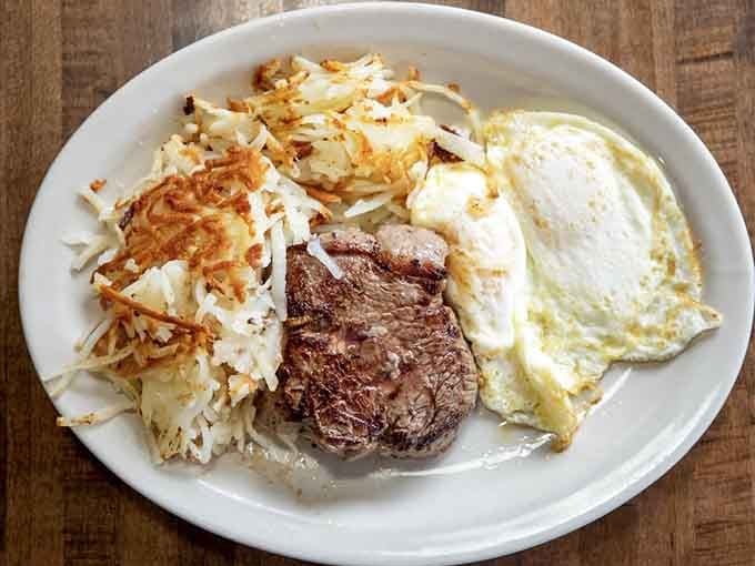 Charbroiled steak, crispy hash browns, and two eggs, a plate that says good morning and means it.