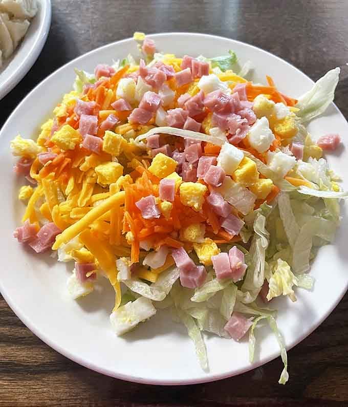 Fresh, colorful, and loaded with ham, cheese, and carrots, proof that salad can actually make you happy.