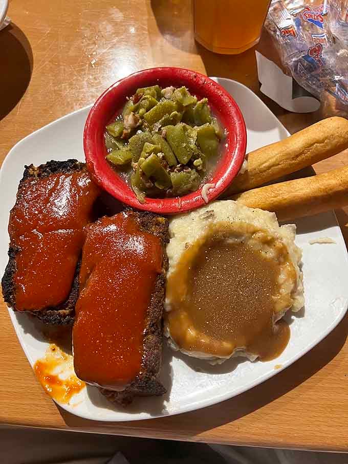 That meatloaf glistening under BBQ sauce is giving serious Sunday dinner vibes, elevated to restaurant perfection.