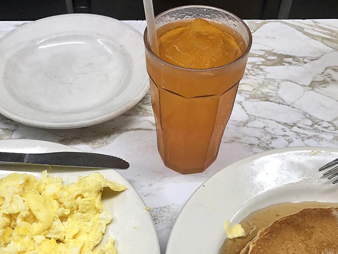 Scrambled eggs, pancakes, and a cold drink at Duly's, because breakfast anytime is a philosophy worth living by.