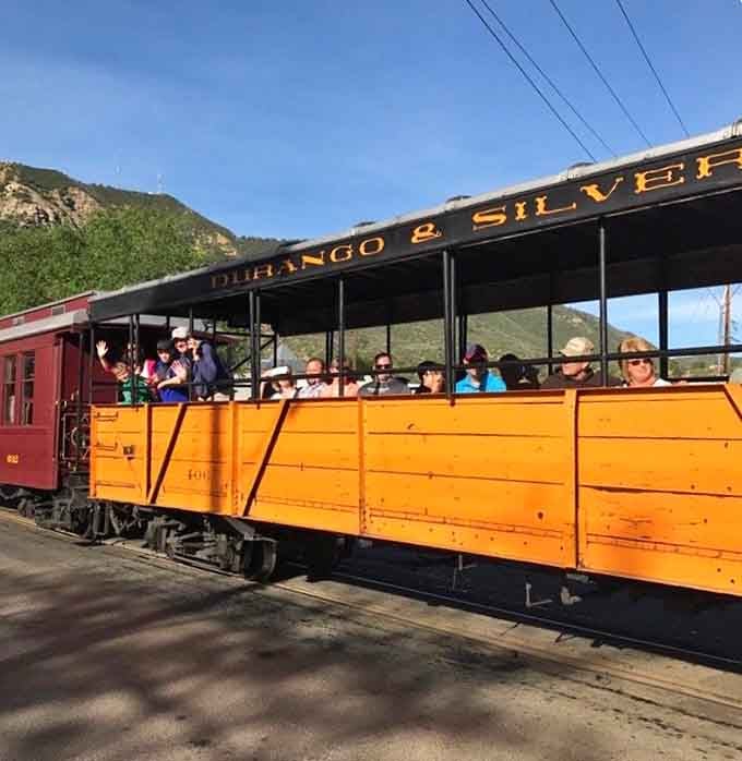 The open-air gondola car puts you directly in the mountain breeze, no filter, no glass, just Colorado.