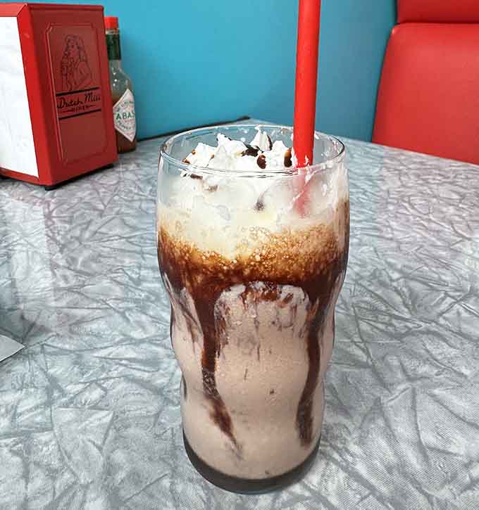 Chocolate drizzle, whipped cream, and a red straw &mdash; this float is pure, unfiltered joy in a glass.