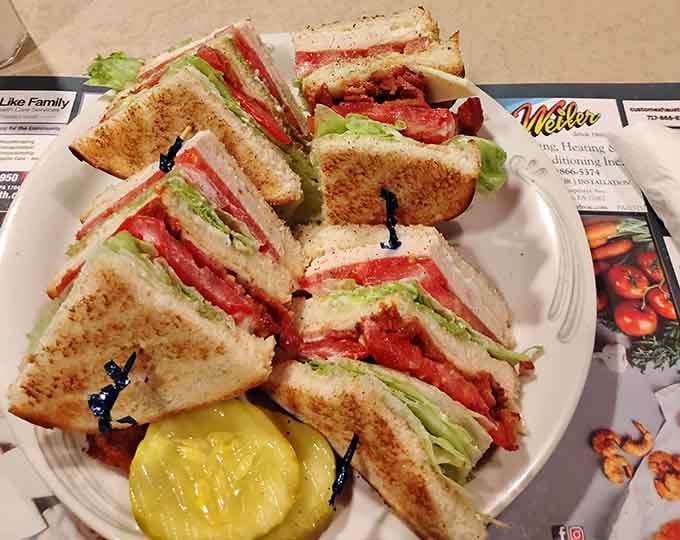 A club sandwich cut into triangles and served with pickles is one of life's most reliable pleasures. This one delivers.