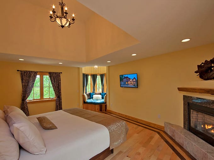 A chandelier, a fireplace, and a window seat with a view. Someone clearly thought this through very carefully.