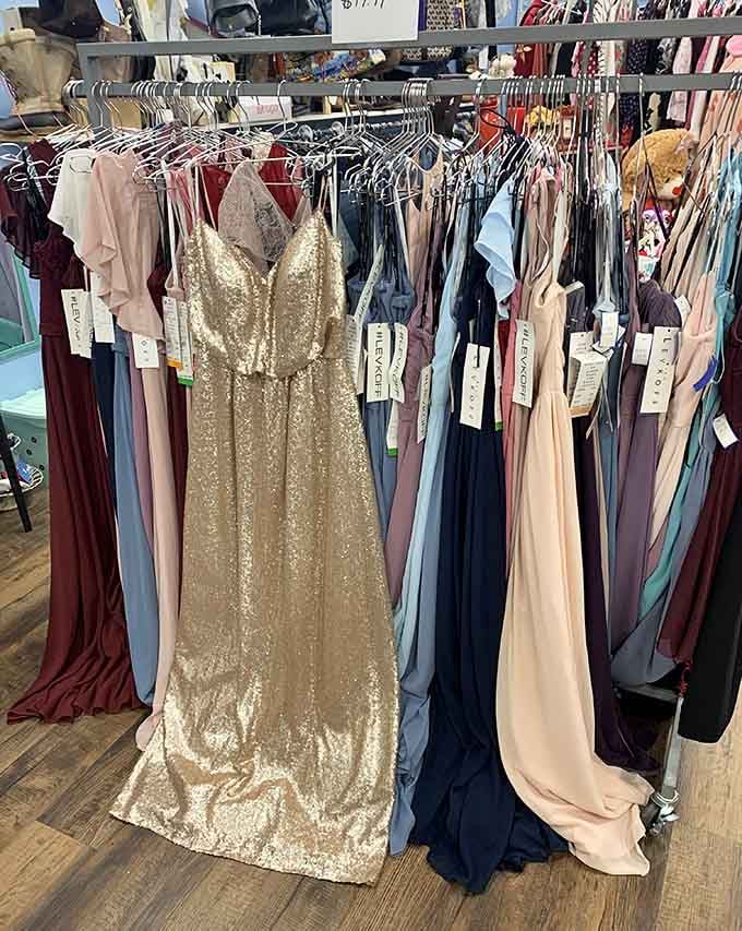 Sequined gowns and formal dresses hanging side by side. Prom night, wedding season, or Tuesday. No judgment here.